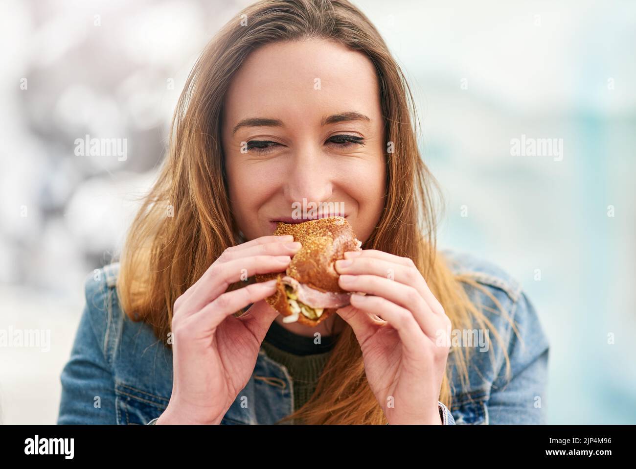 Quick snack then back to the fun. Portrait of a beautiful young woman ...