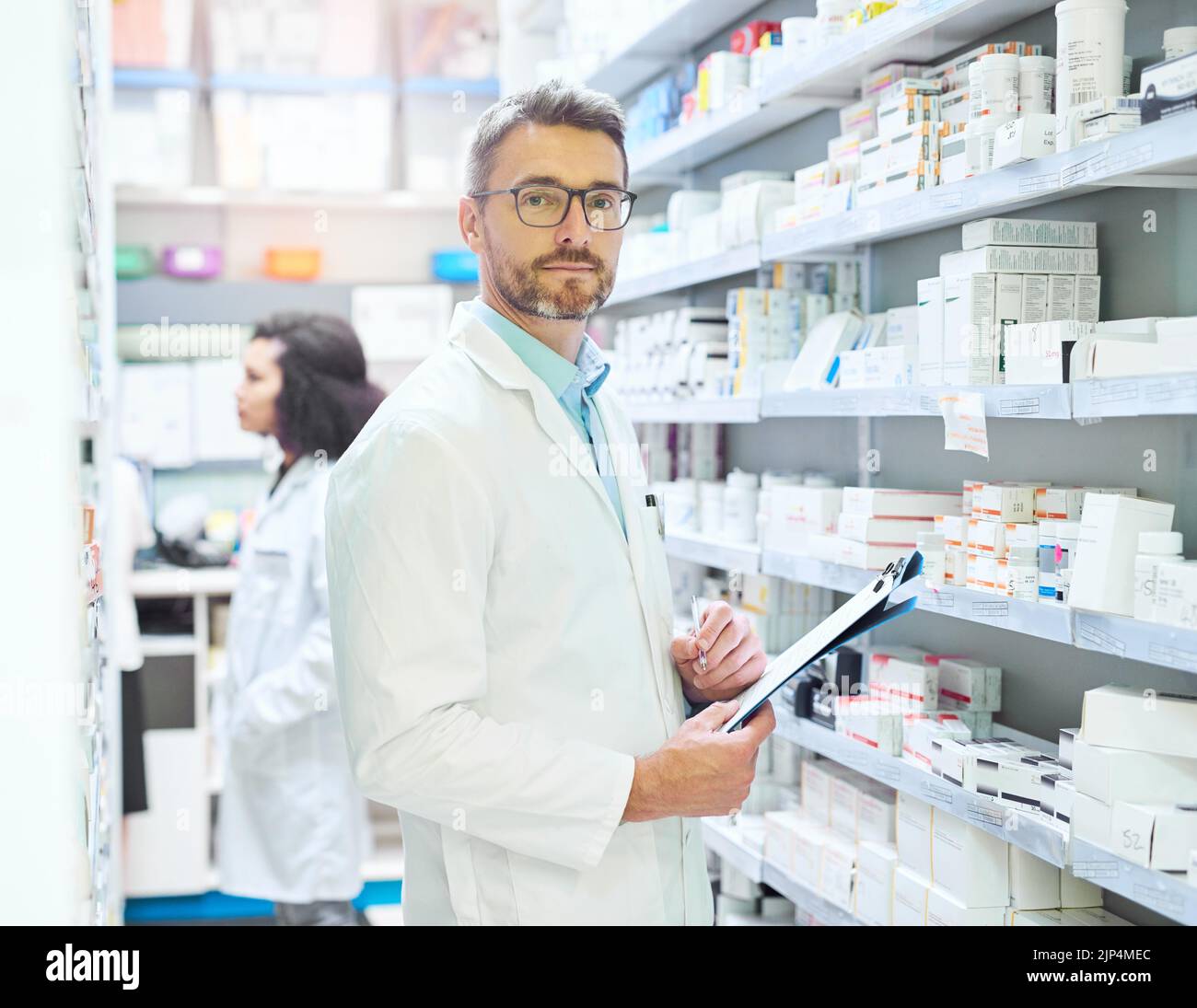 One moment while I fill your prescription. a mature man doing inventory ...