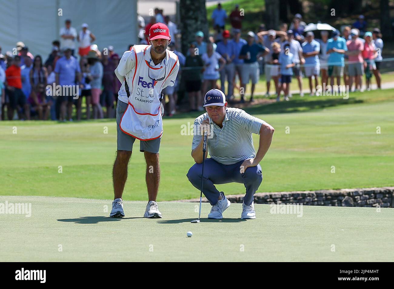 August 14, 2022: Trey Mullinax and his caddie size up his putt during ...