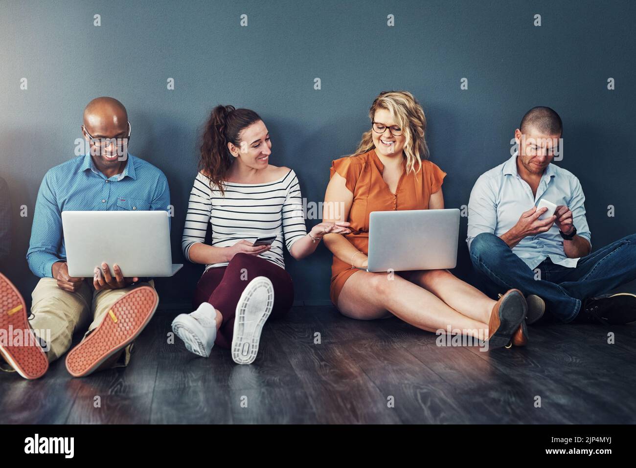 Smiling, diverse group of casual and modern business people with their ...