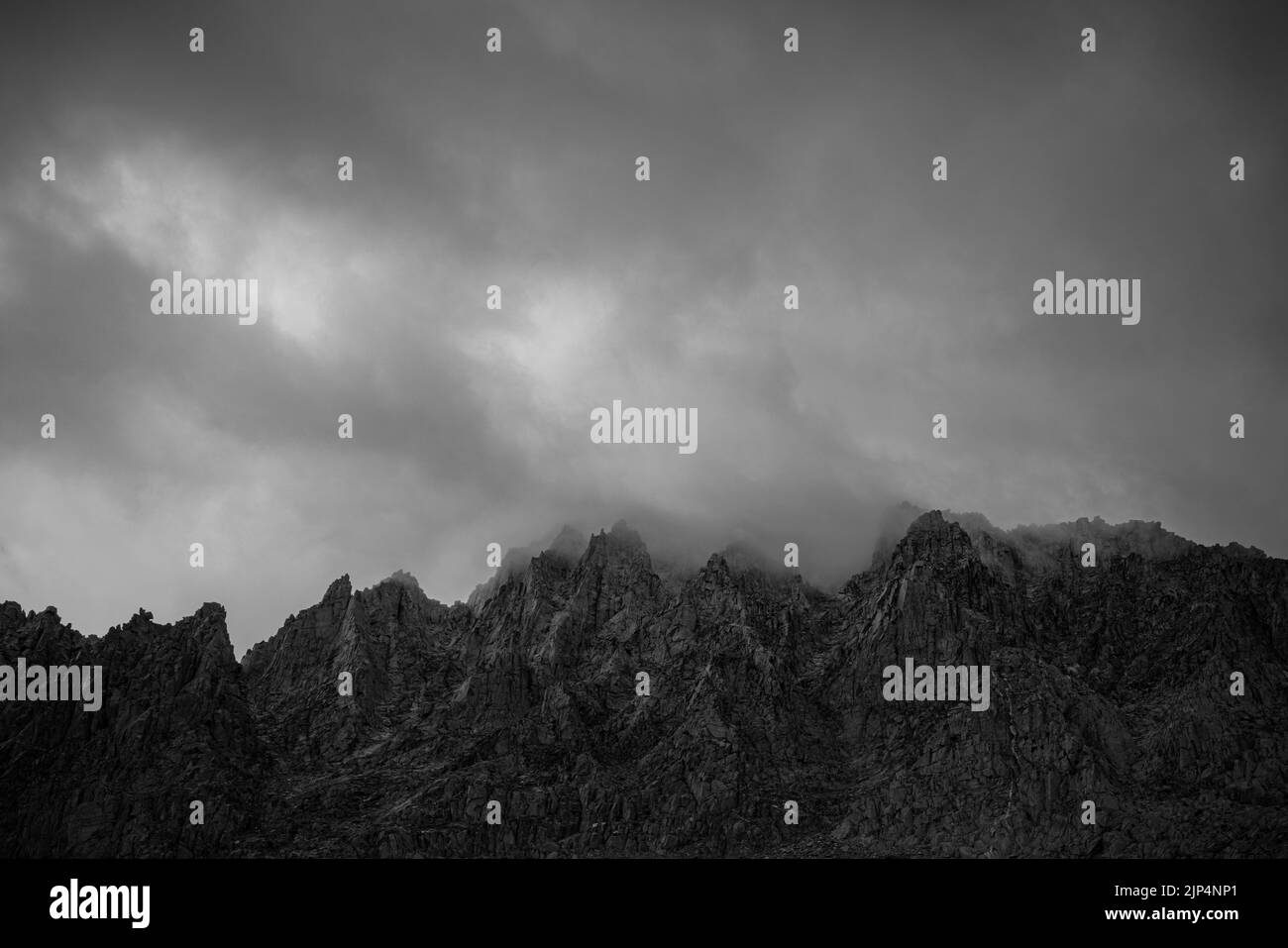 Moody clouds over craggy peaks in Evolution basin Stock Photo - Alamy