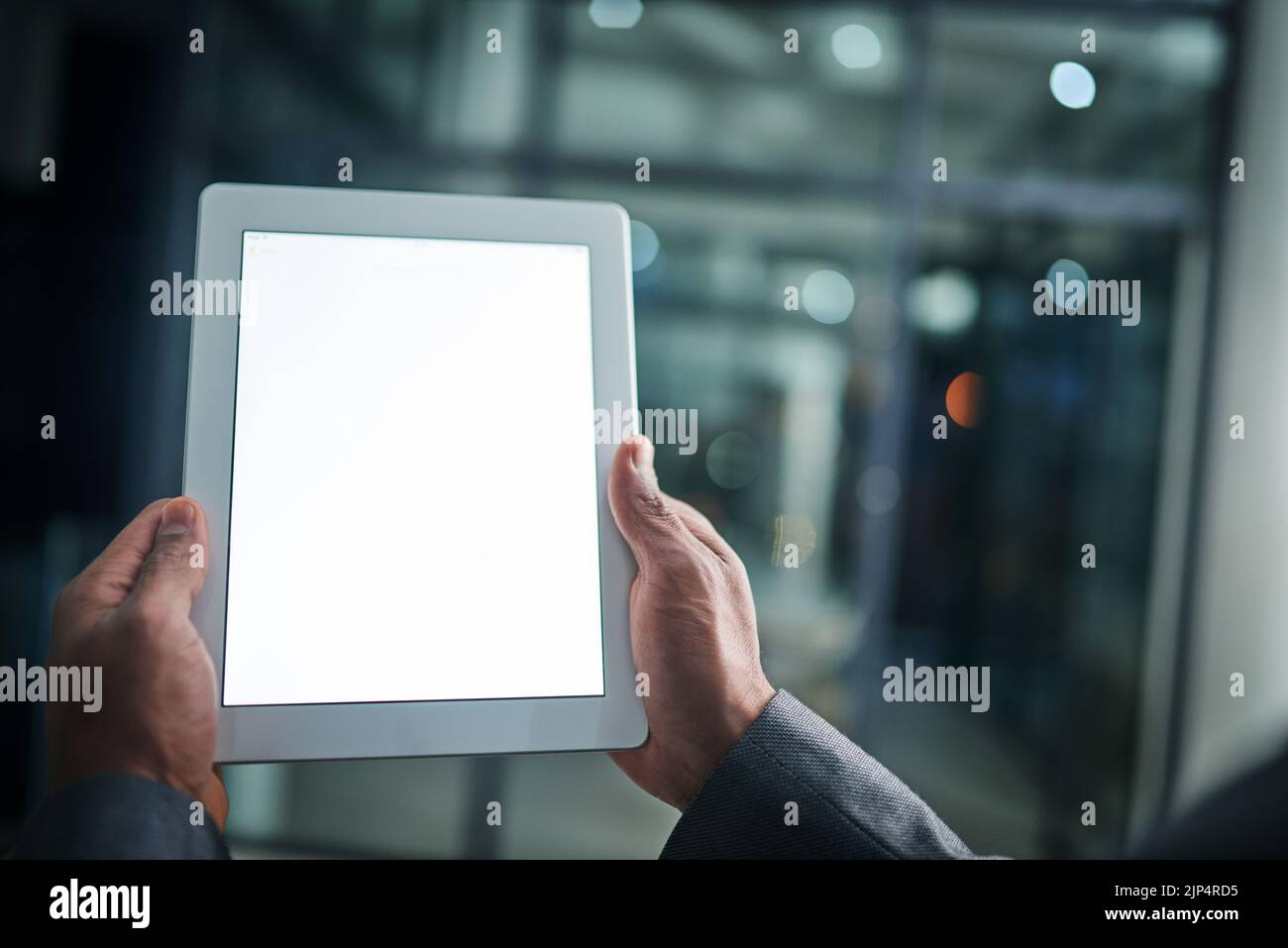 Man holding tablet in hand with blank screen over a isolated copy space ...