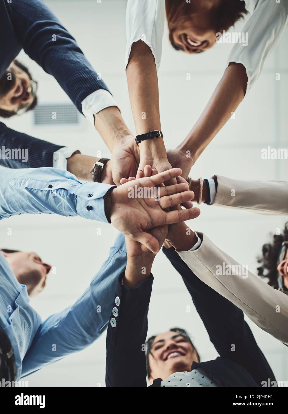 Teamwork, collaboration and unity between business people with their hands stacked for project ...