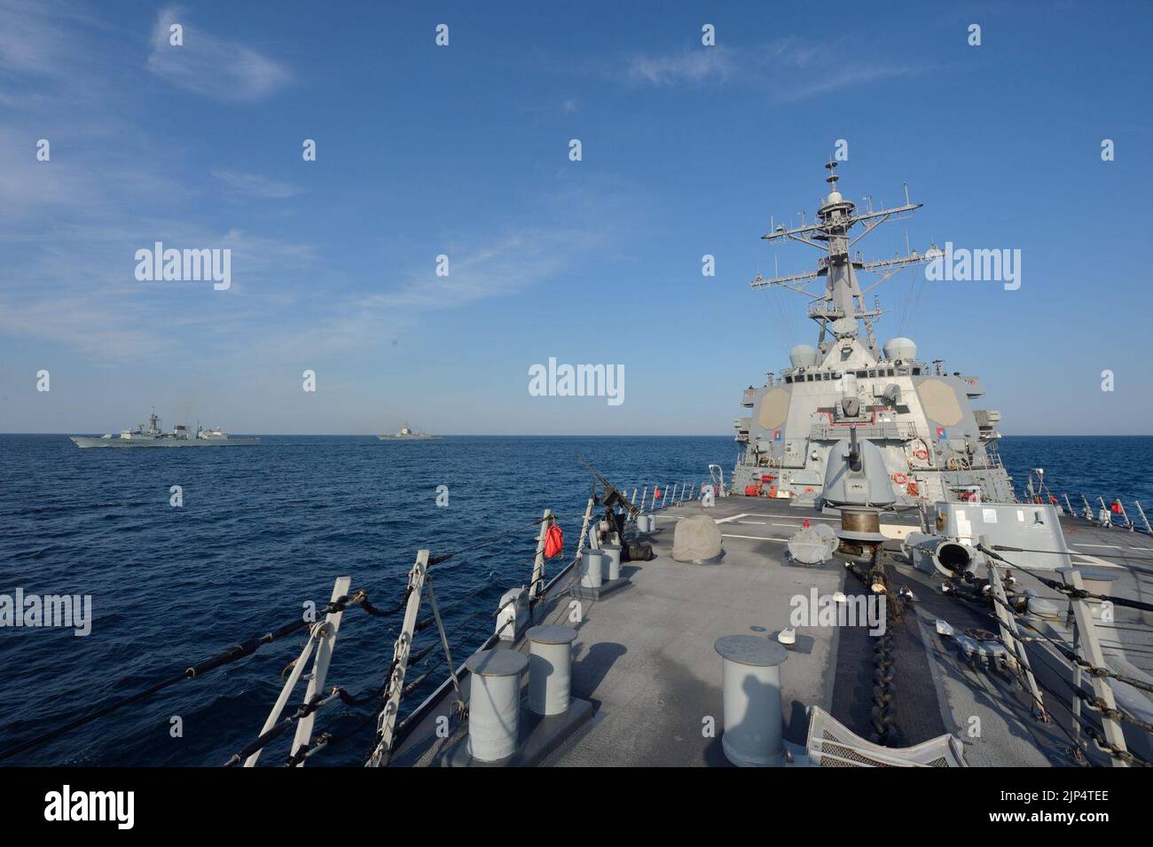 The guided missile destroyer USS Ross (DDG 71) transits in formation ...