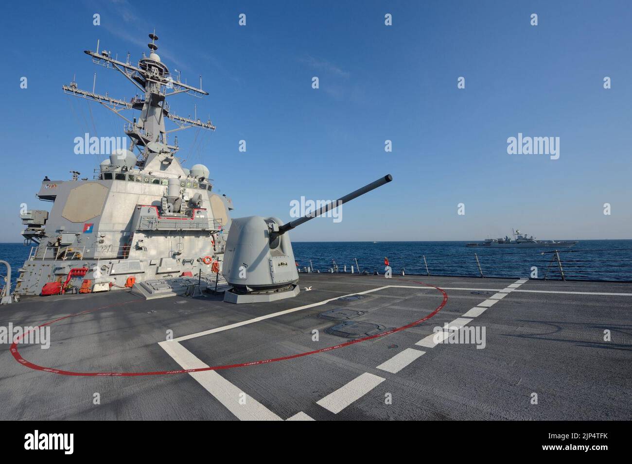The guided missile destroyer USS Ross (DDG 71) transits in formation ...