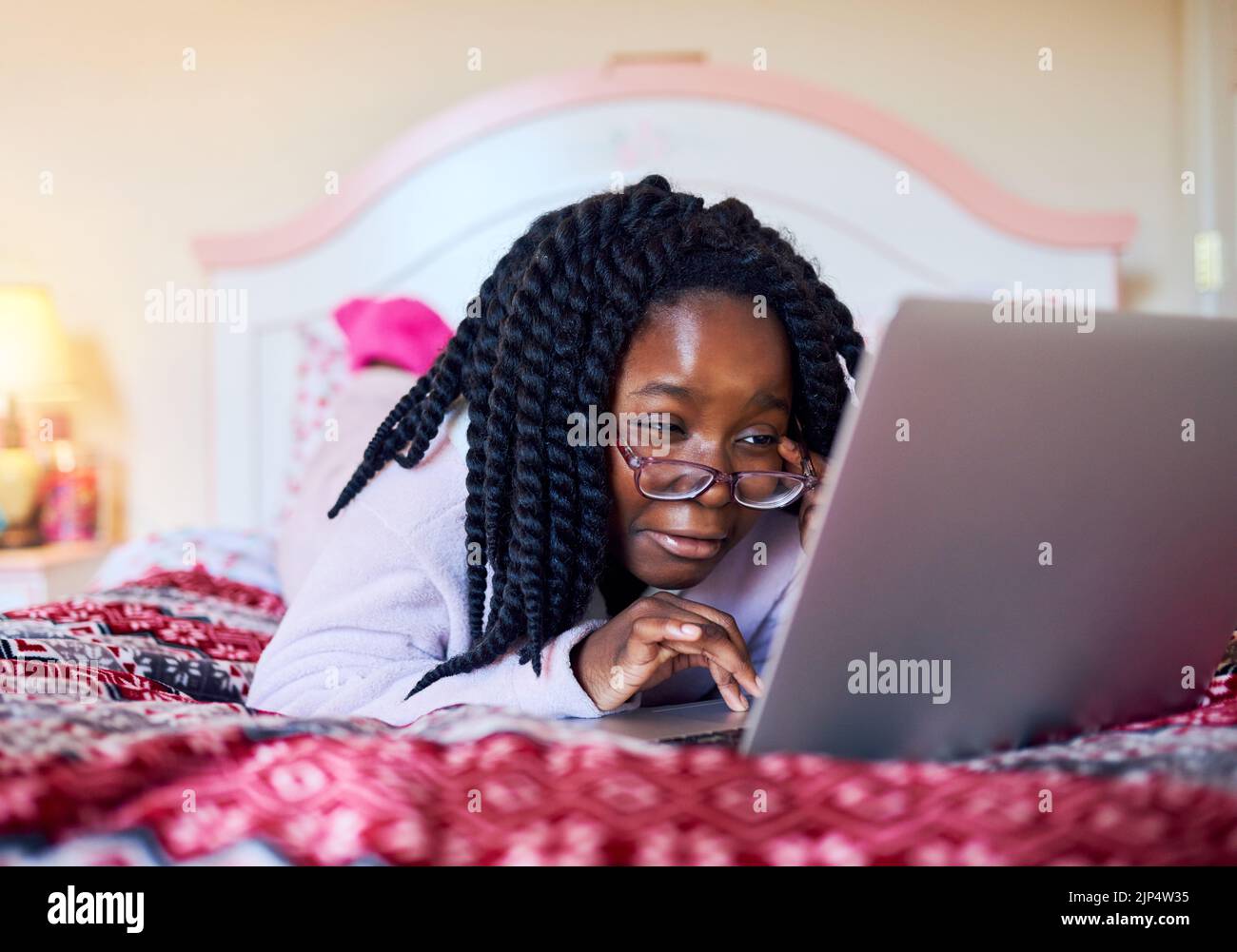 Learning about technology. an adorable little girl using a laptop while ...