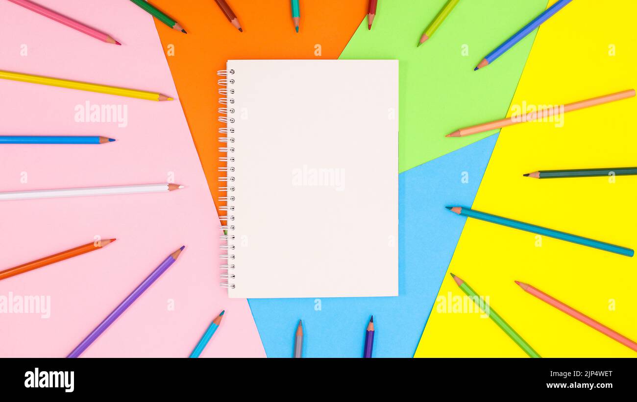 Copy space background with ope notebook and colorful pencils. Flat lay ...