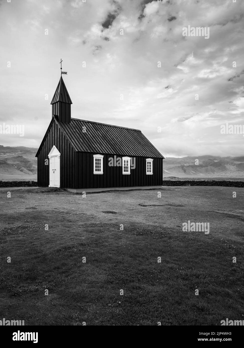 A vertical grayscale shot of the historic black church in Budir ...