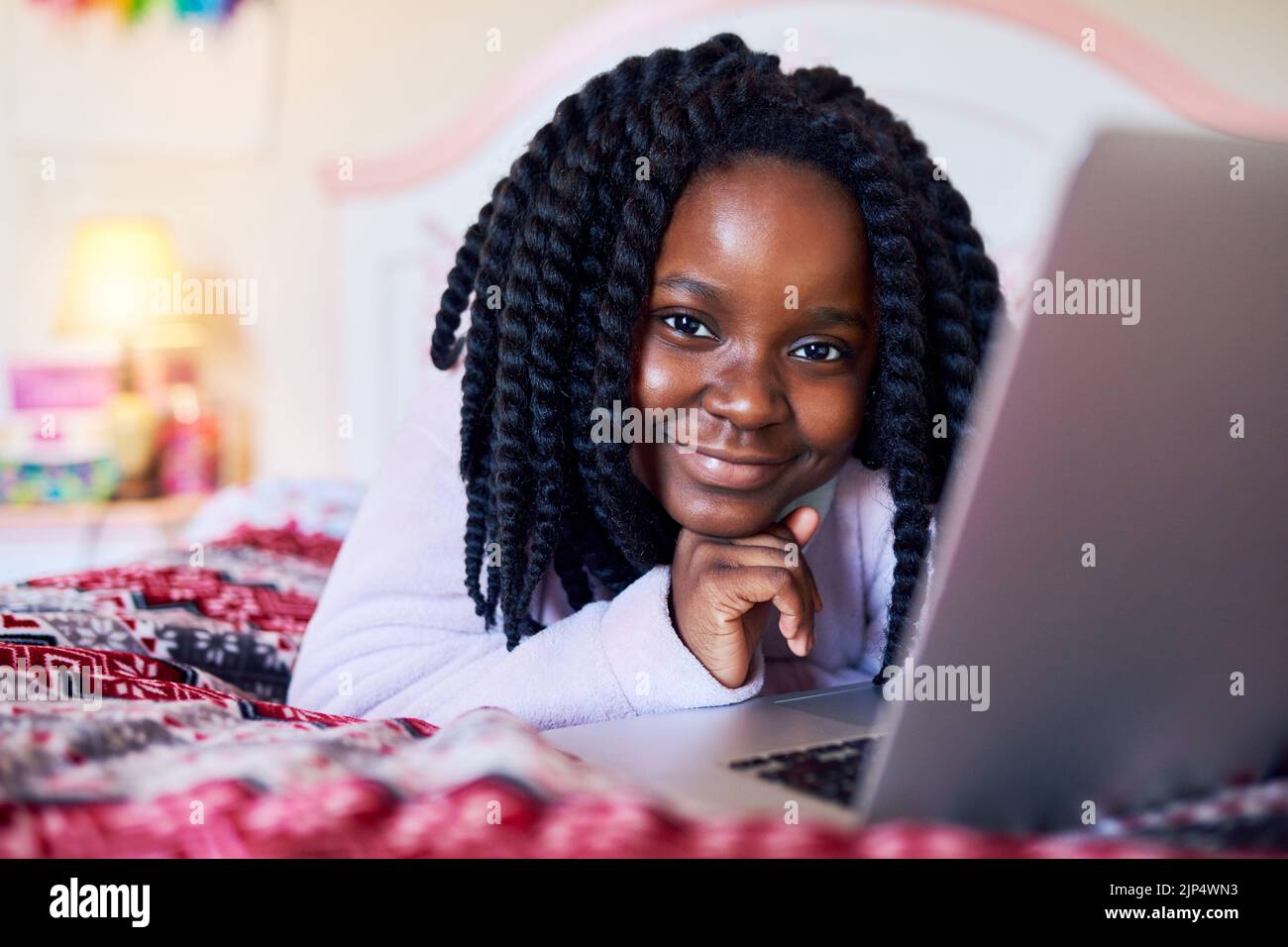 Tech savvy at a young age. an adorable little girl using a laptop while ...