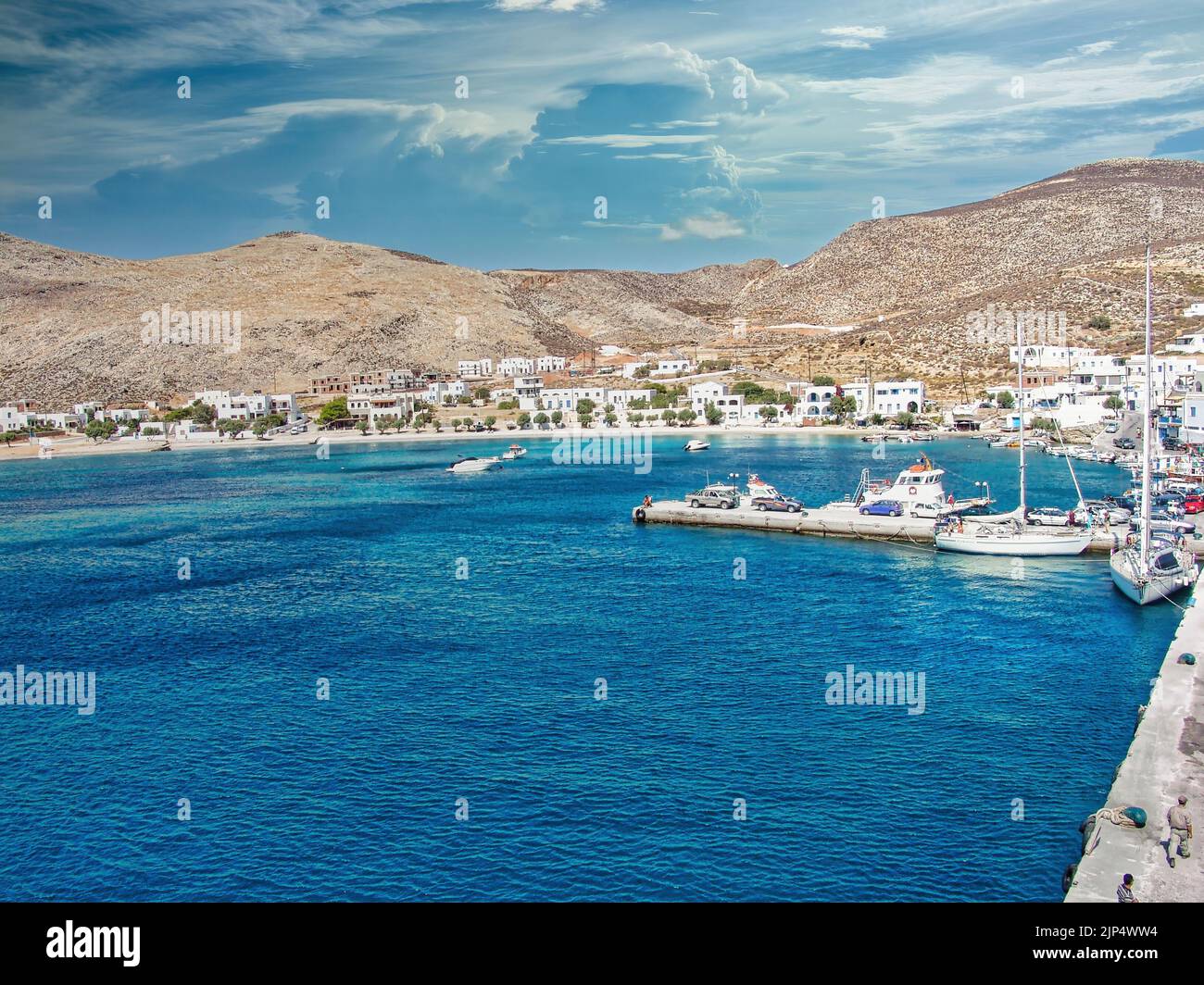 A gorgeous scenery of Karavostasi port with sailing boats and white ...
