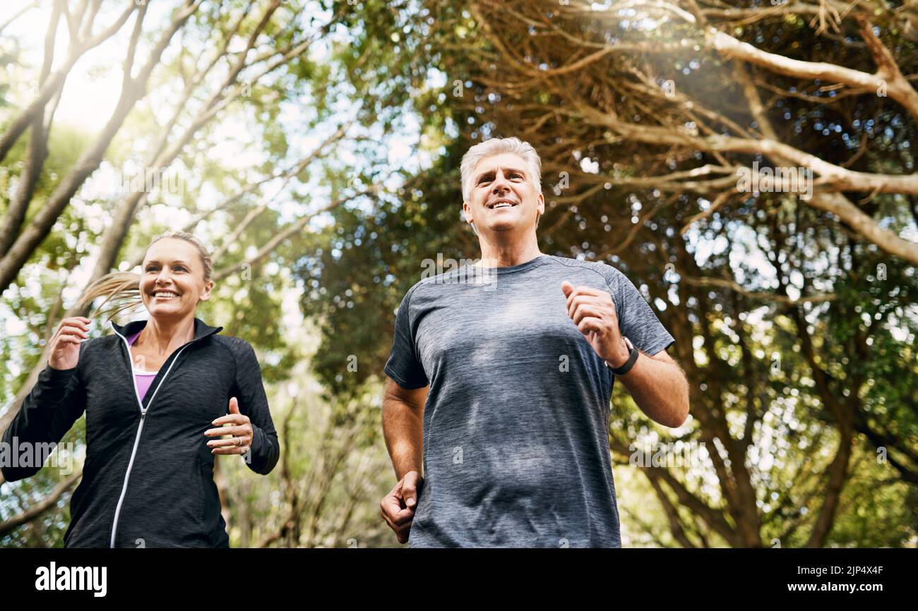 Fit, active and healthy mature couple jogging, running and enjoying ...