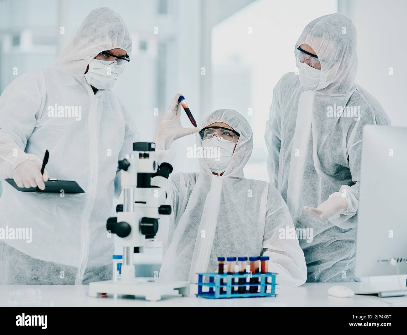 Group of doctors and scientists conducting medical research on viruses ...