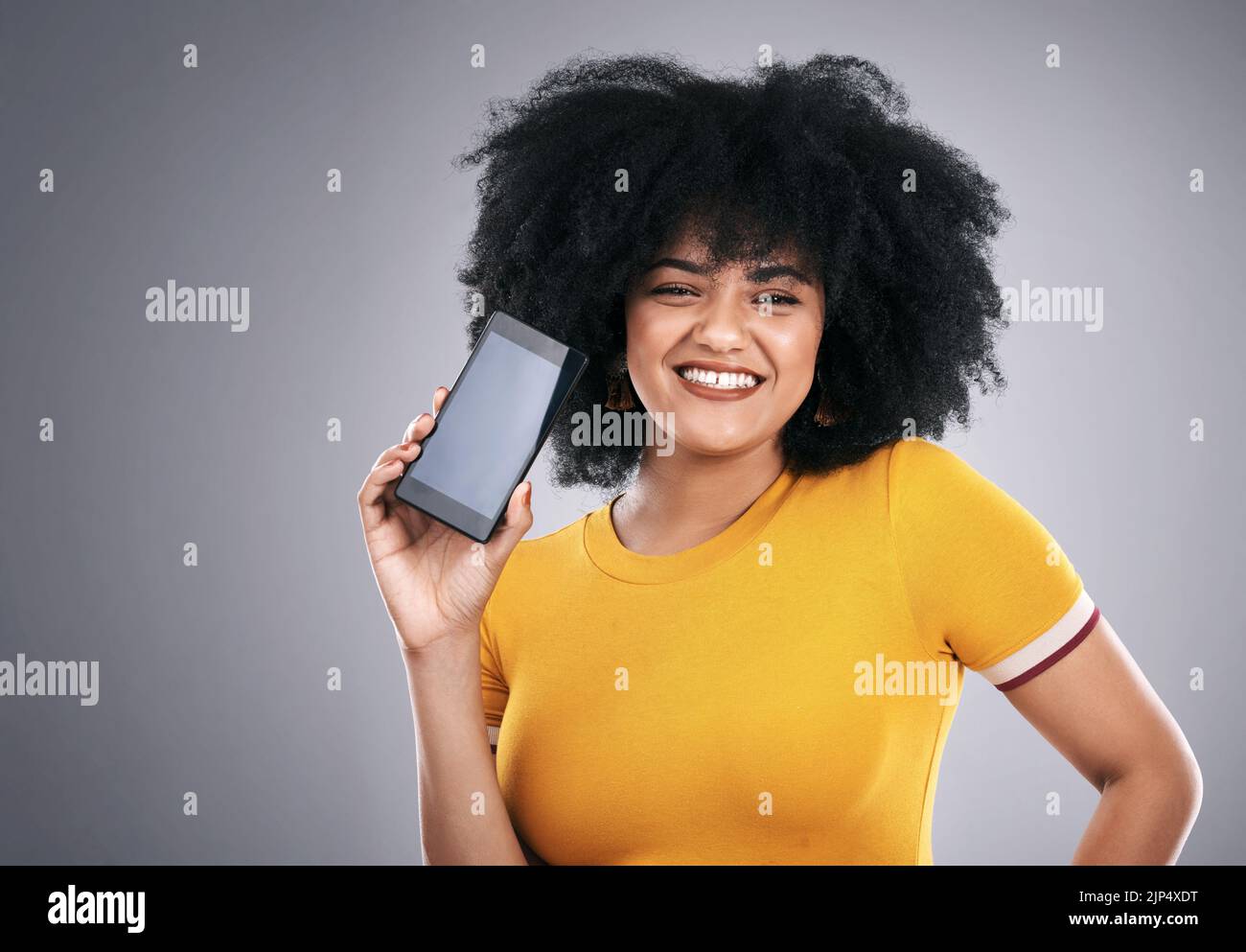 The perfect device to travel with. Studio shot of an attractive young ...