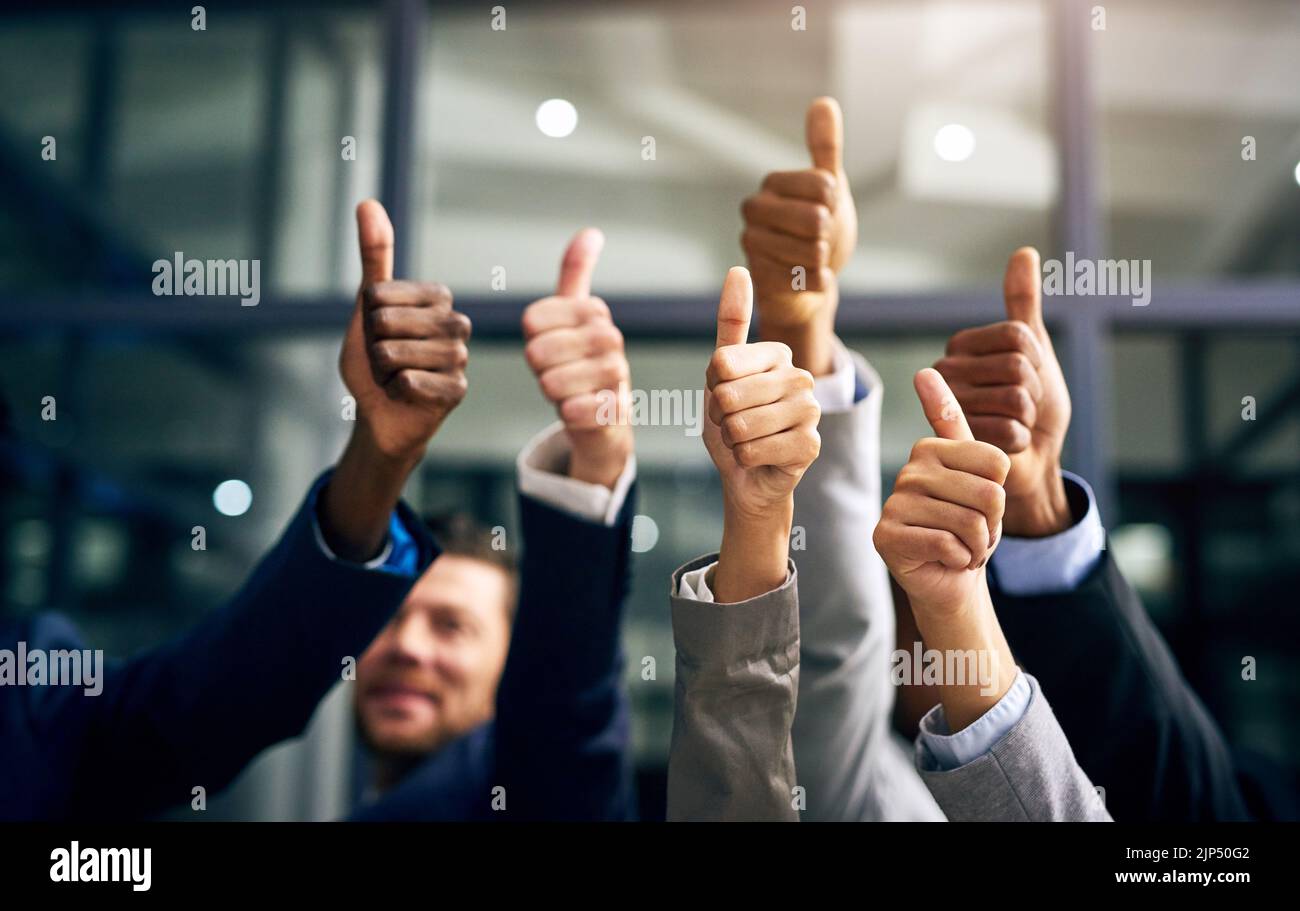Thumbs up with hands of a business team or group giving their approval ...