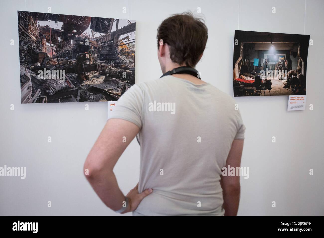 Kyiv, Ukraine. 14th Aug, 2022. A man watches pictures by Azov soldier ...