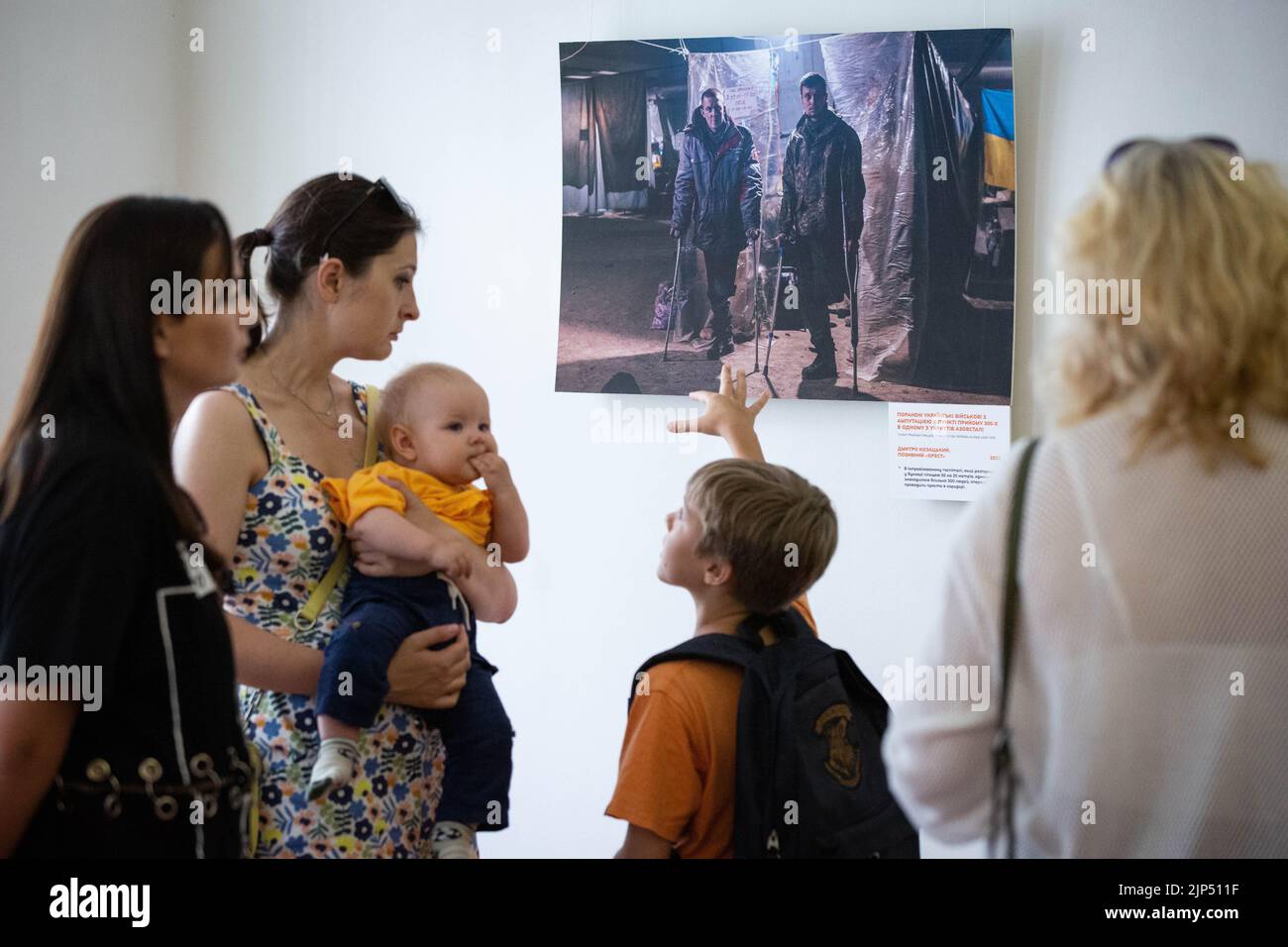 Kyiv, Ukraine. 14th Aug, 2022. People watch pictures by Azov soldier ...