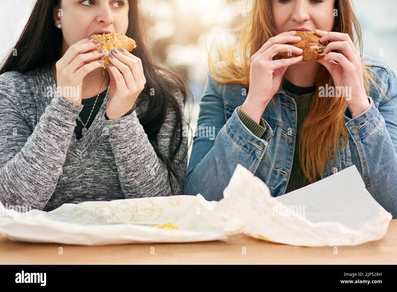 Eating yummy sandwiches with my bestie. two female best friends eating ...