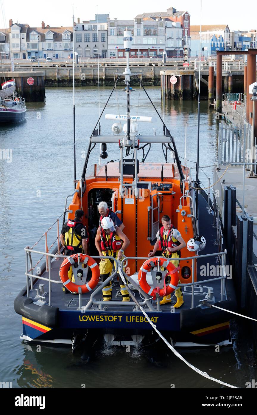 Lifeboat crew securing mooring lines, Lowestoft, Suffolk, England ...