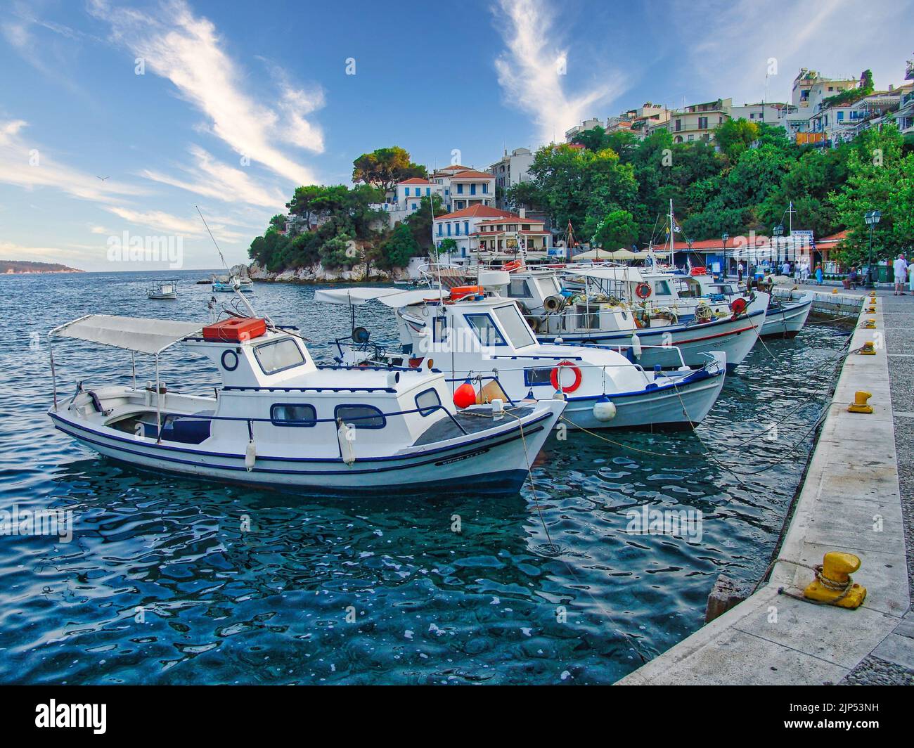 The fishing boats and yachts moored on the harbor in the main city of ...