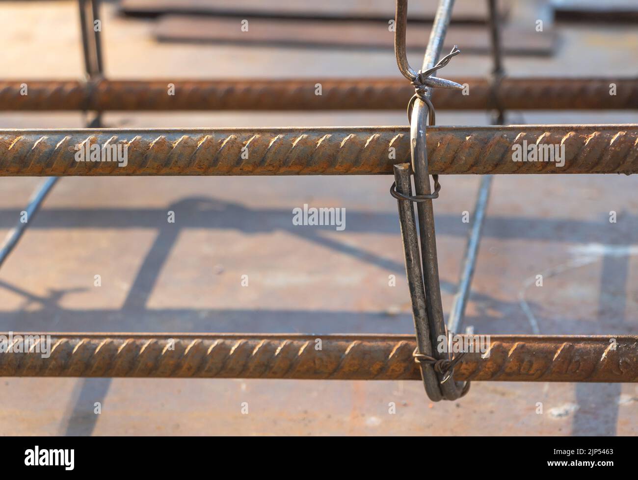 Anonymous worker fixing rebars in sunlight - Unrecognizable builder ...