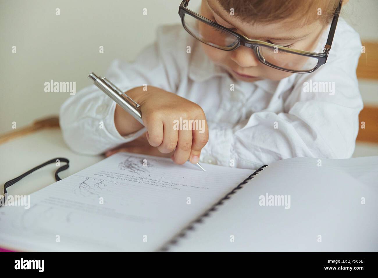 Charming child plays pretending to be a teacher Stock Photo - Alamy