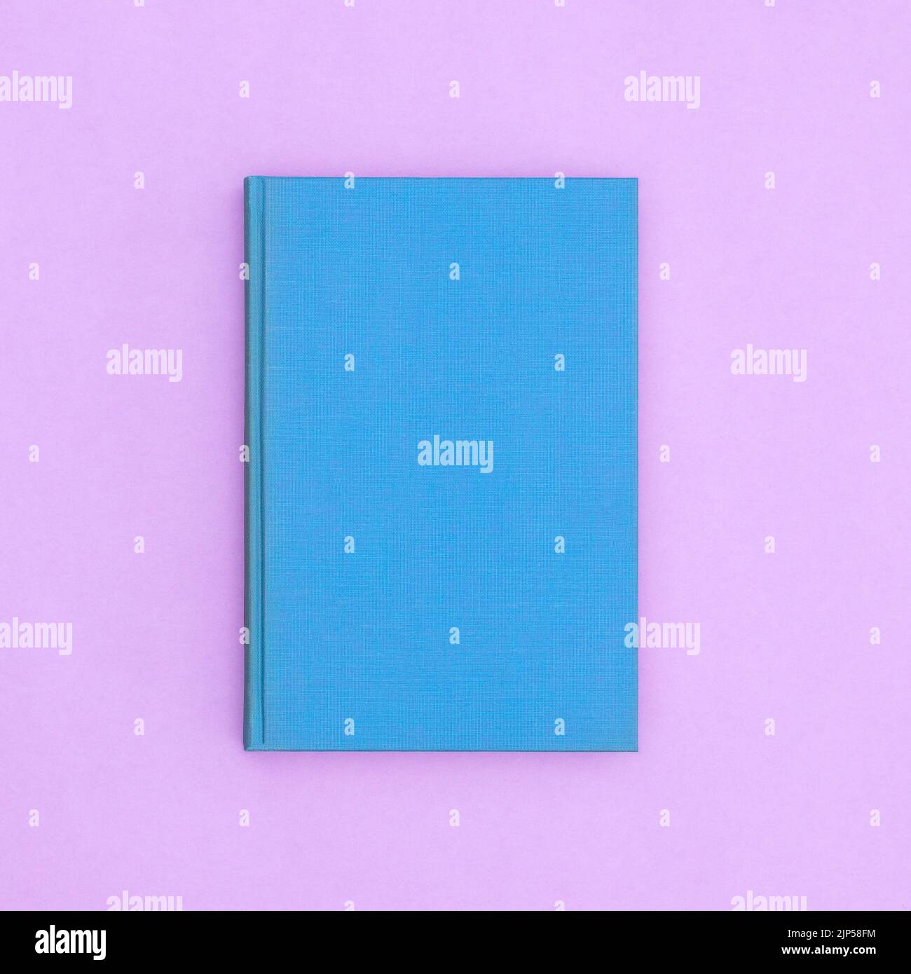 Blue hardcover vintage book on pastel purple background. Flat lay copy ...