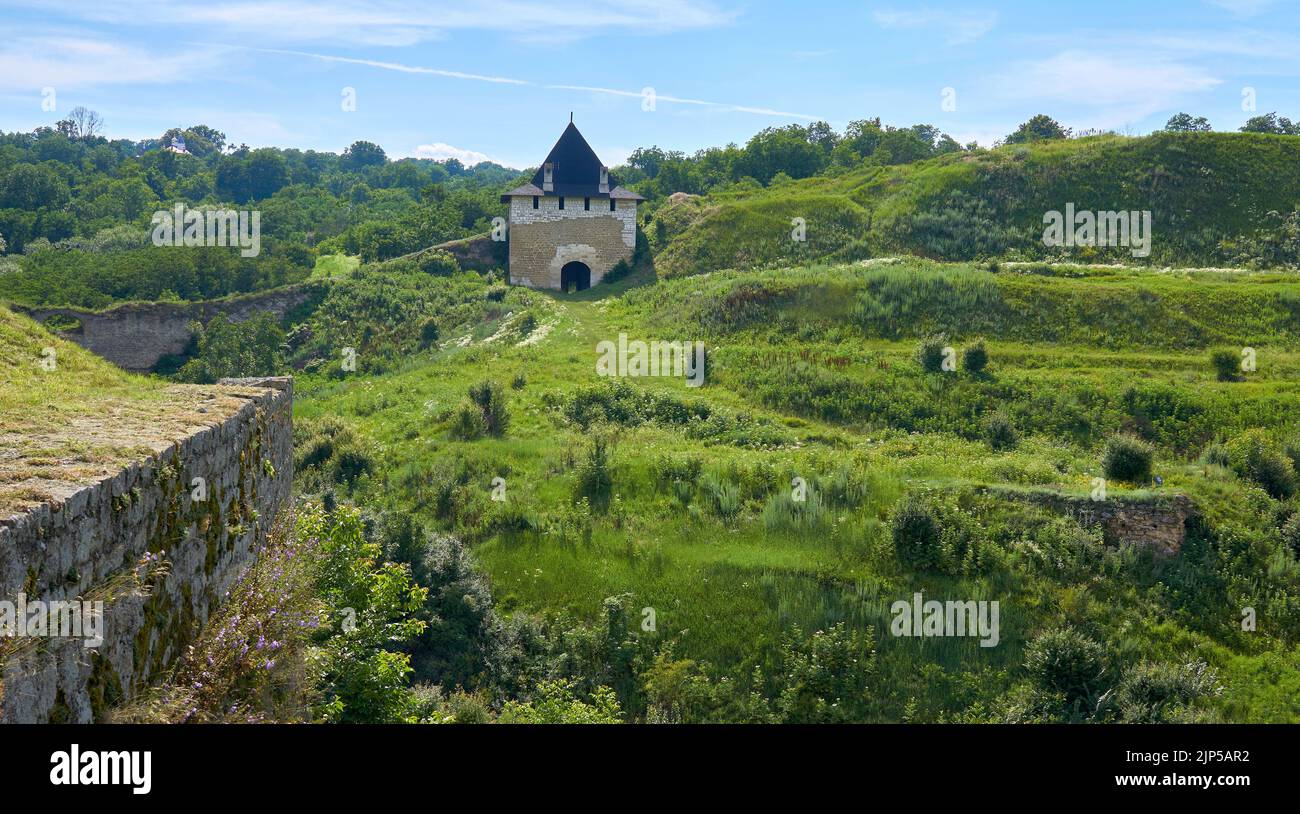 Watchtower entrance in the old fortress wall on the green hill Stock ...