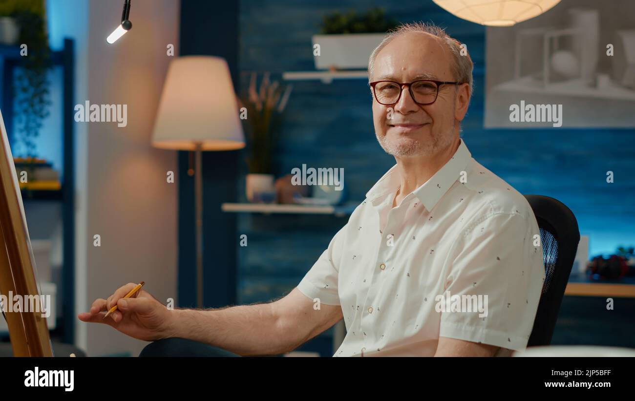 Portrait of senior man with professional drawing skills creating ...