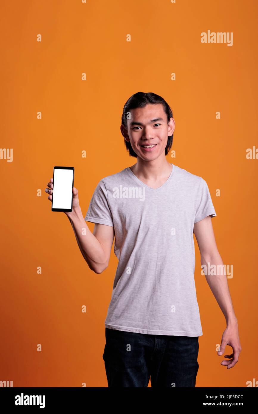 Asian Teenager Showing Smartphone With White Blank Screen Young Man