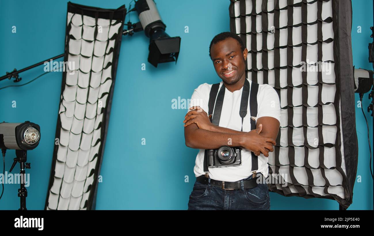 African american man having backstage photography equipment, using ...