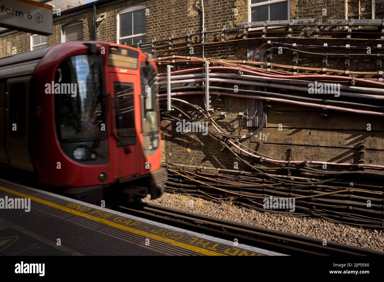 Cables and trains at underground station in Whitechapel,London,England ...
