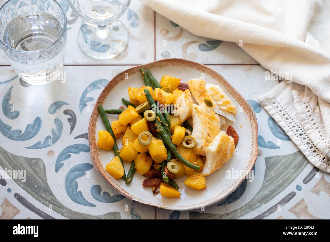 Spanish dish of cod with potato and chorizo Stock Photo - Alamy