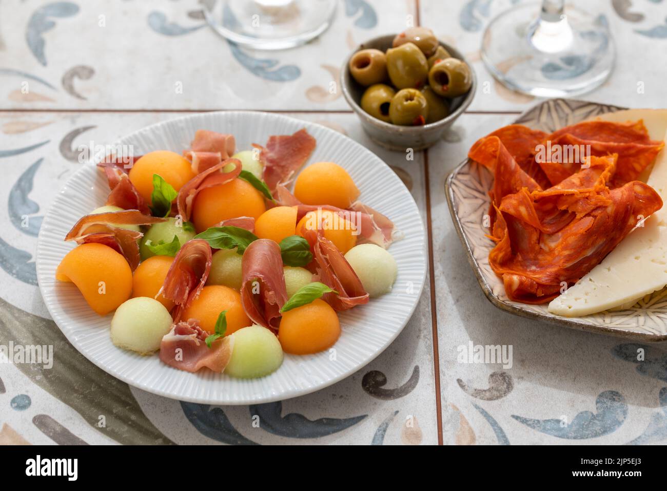 Spanish tapas, melon and ham, olives, cheese and chorizo Stock Photo ...