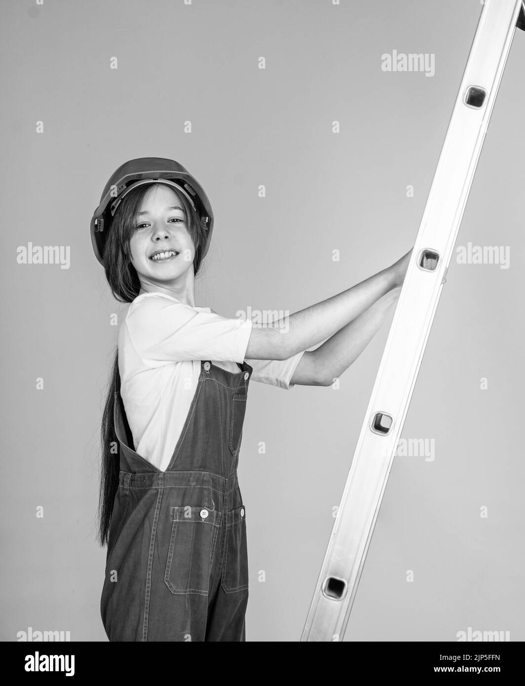 girl kid in hard hat on construction site use ladder, builder Stock ...
