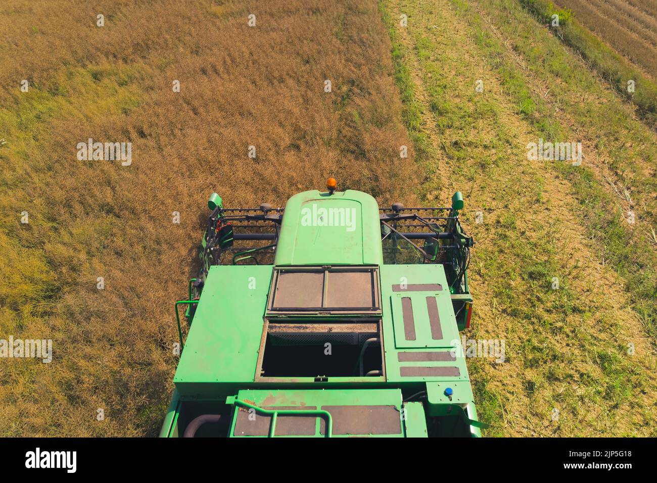 Top front view of a green agricultural combine harvester with a ...