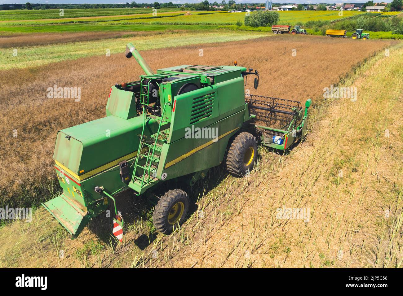 Aerial view of a green agricultural combine with a revolving reel ...