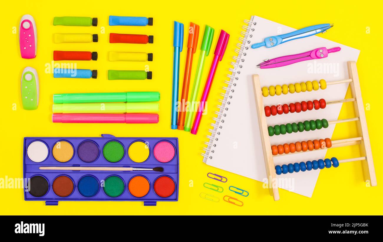 Vibrant yellow background with Back to school stationery arrangement ...