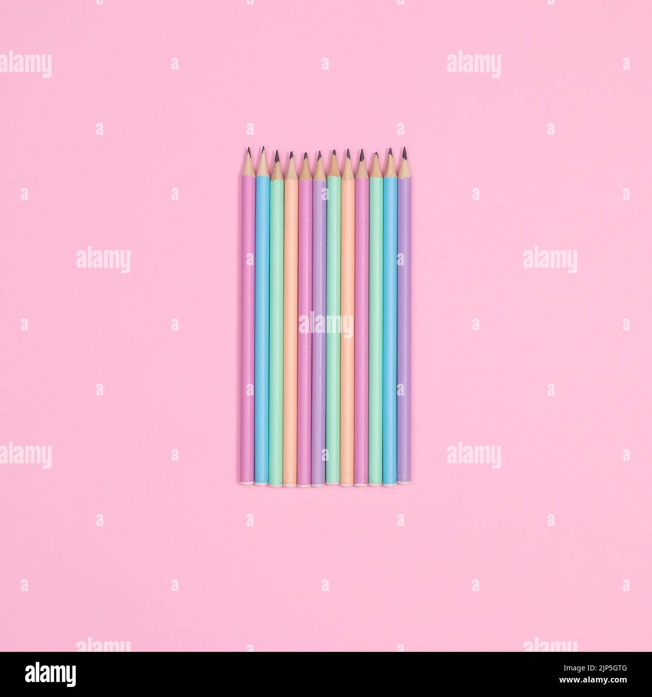 Colorful pastel wooden pencils on pastel pink background. Flat lay ...