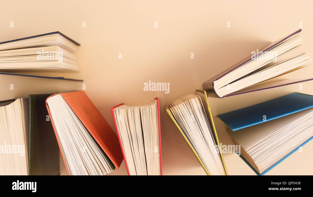 Pastel beige background with vintage colorful books. Flat lay copy ...