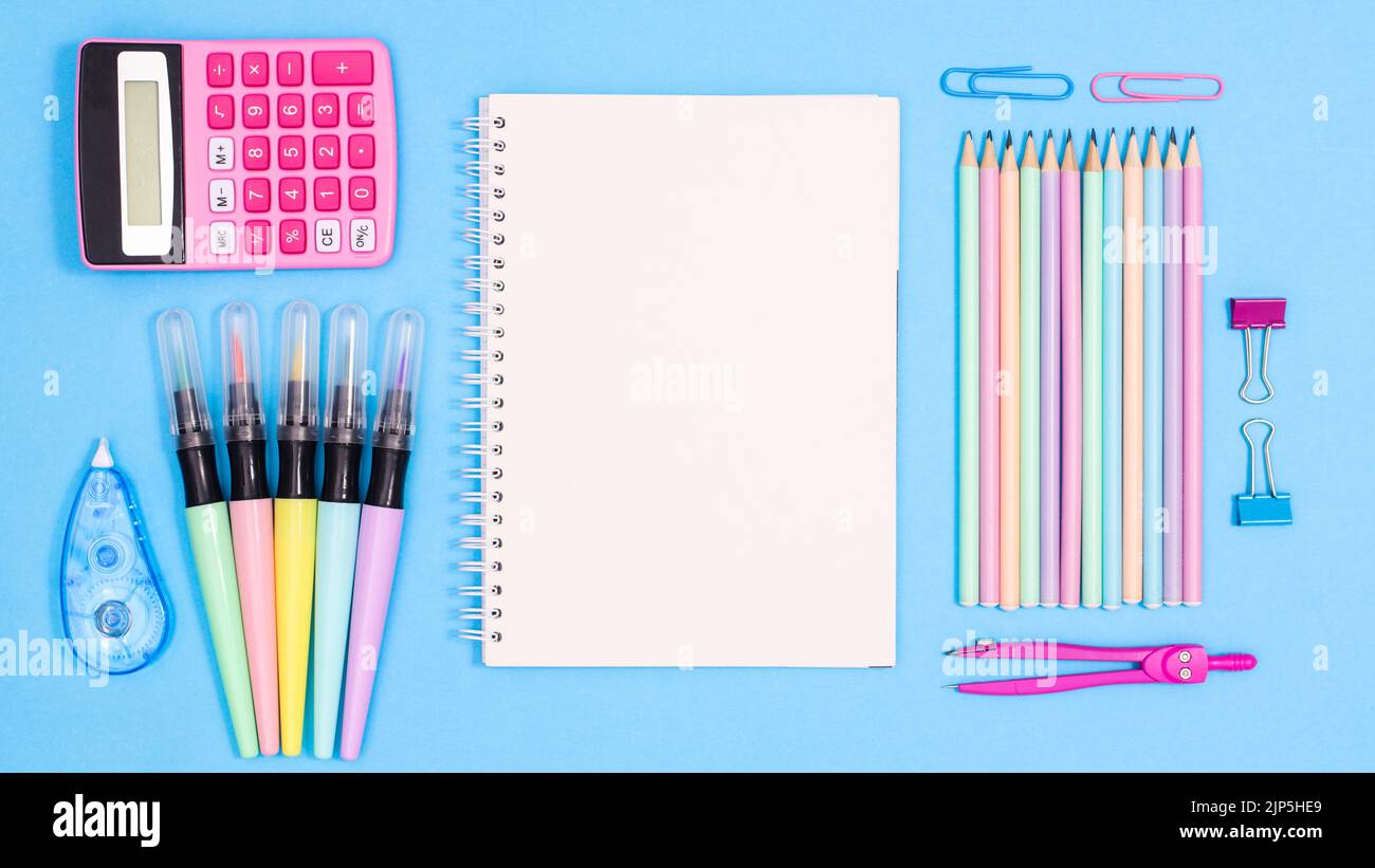 Back to school pastel blue background with school supplies and paper ...