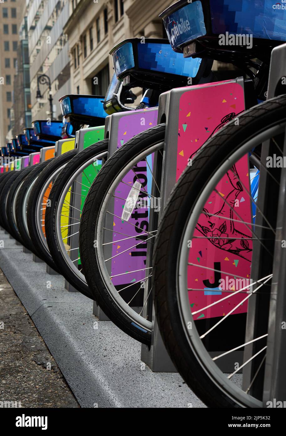 A vertical shot of a city bike station on a pavement in New York City ...