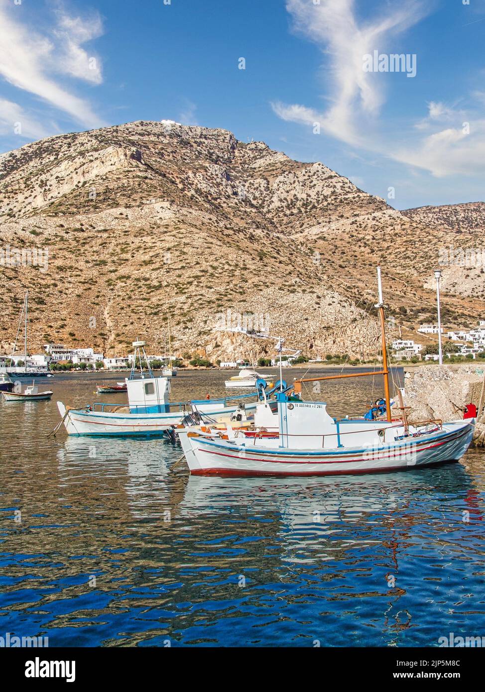 A vertical shot of boats on the water near Kamares village in Crete ...