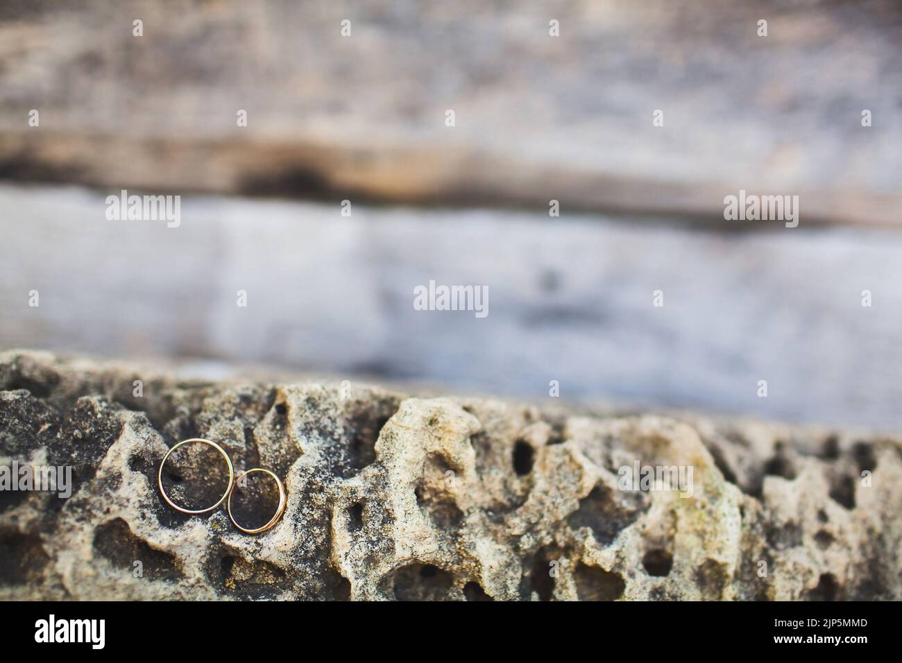 Two wedding rings on a grey stone Stock Photo - Alamy
