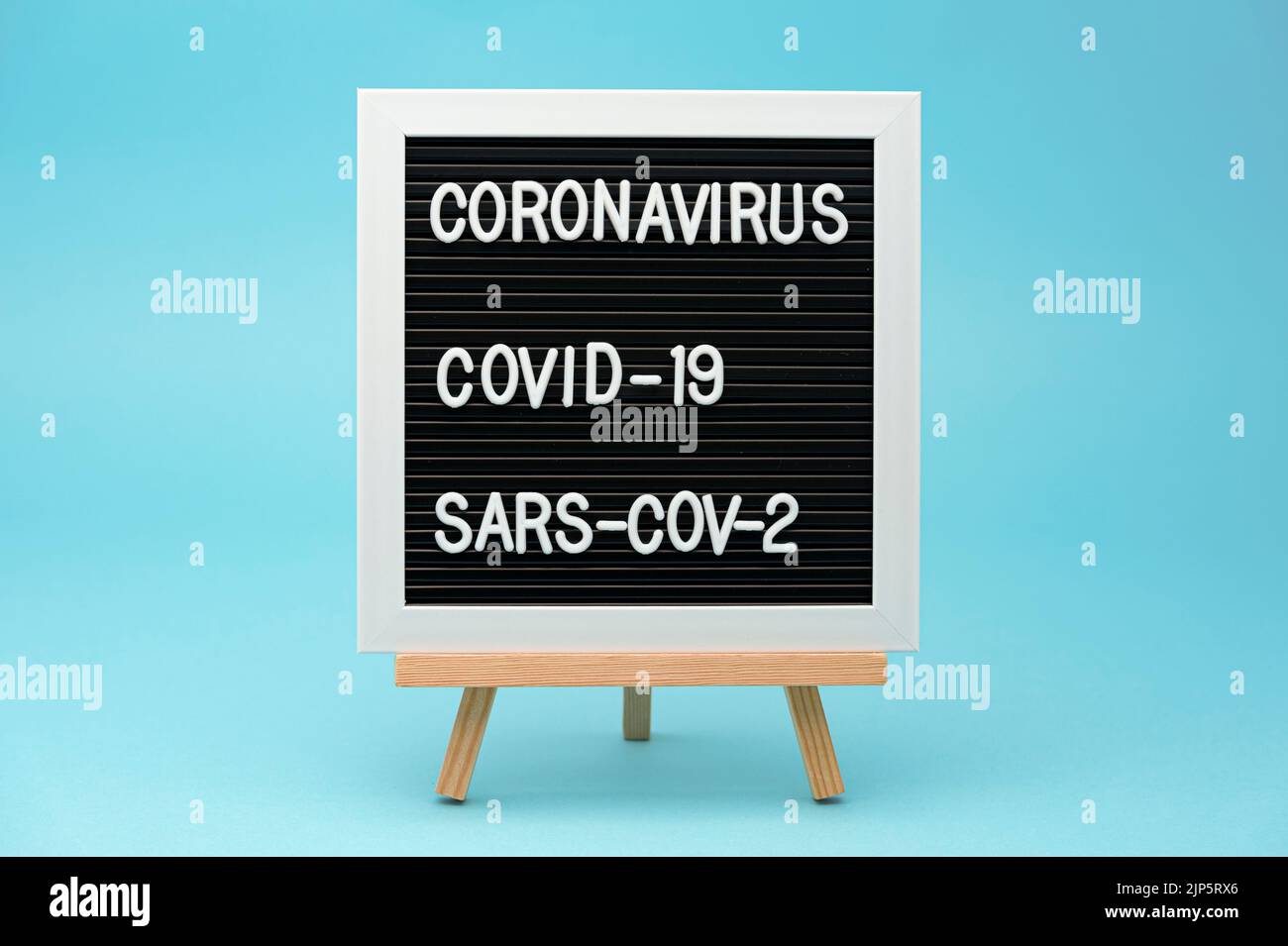 Writing board: CORONAVIRUS, COVID-19 and SARS-COV-2. isolated on blue ...
