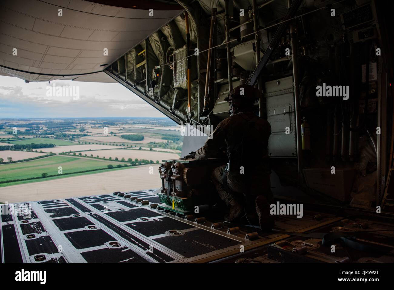 A U.S. Air Force loadmaster assigned to the 352d Special Operations Wing waits for the signal to ...
