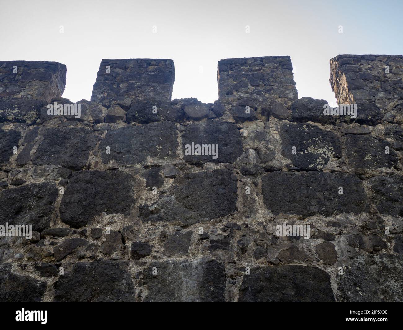 Remains of an old castle. Wall with teeth. Ancient fortifications made ...