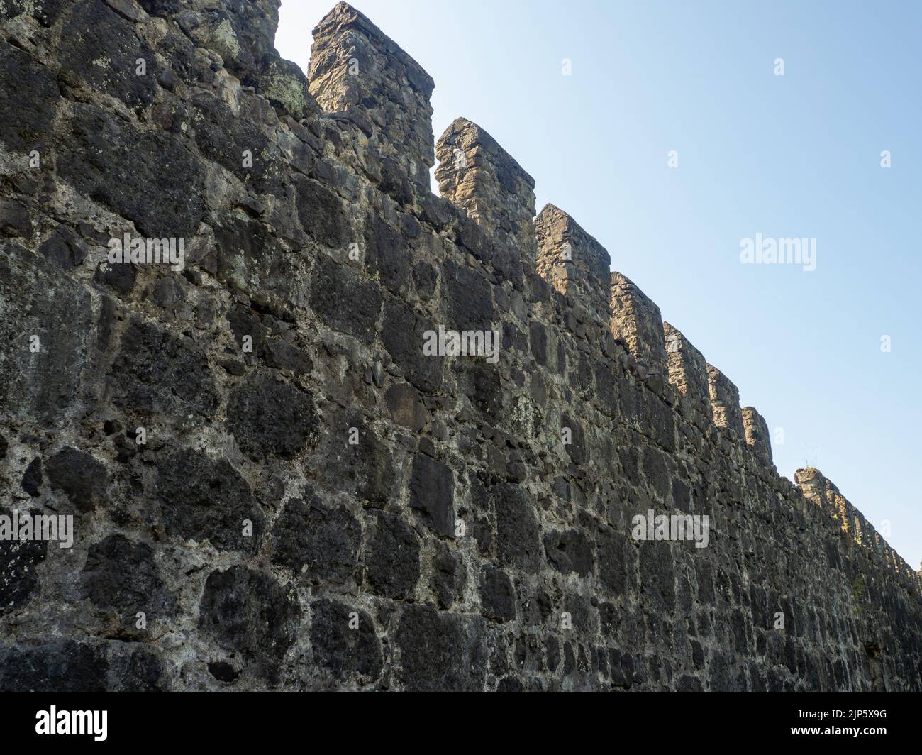 Remains of an old castle. Wall with teeth. Ancient fortifications made ...