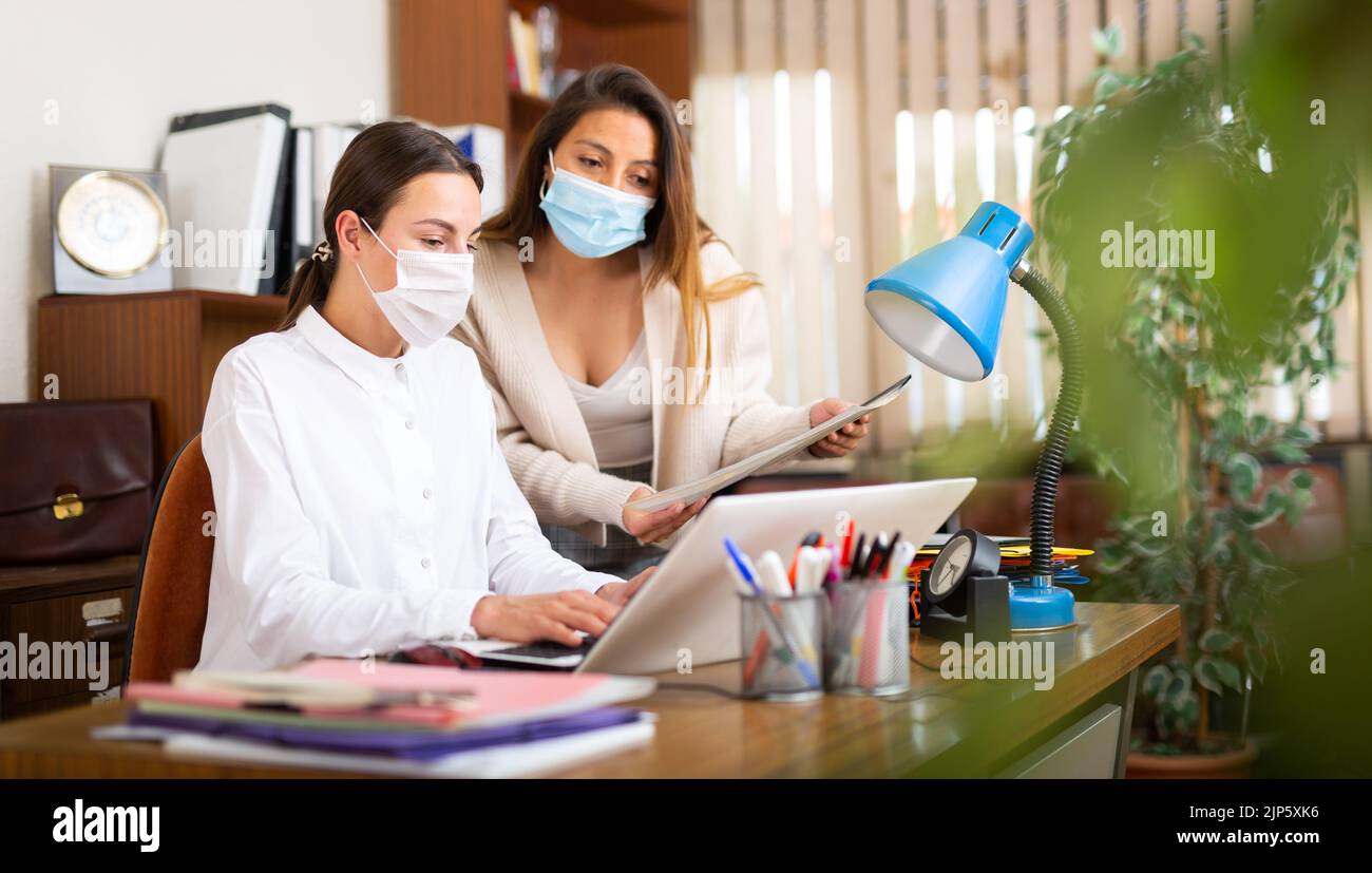 Portrait of two business woman in protective face masks Stock Photo - Alamy