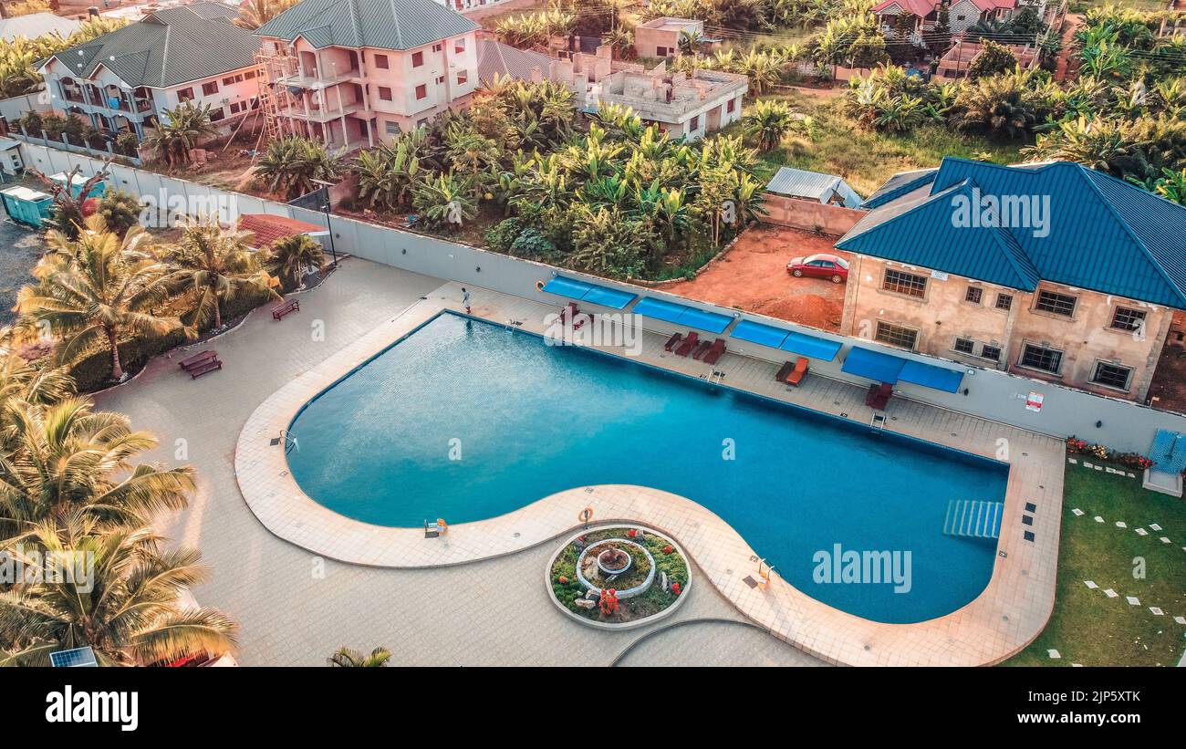 A top view of an asymmetrical pool in the backyard with beautiful ...