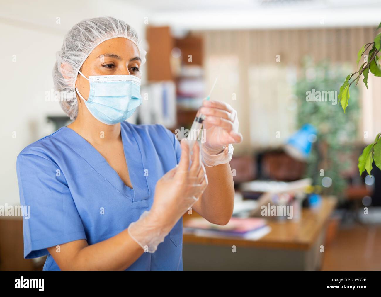 Confident woman doctor holding syringe for injection Stock Photo - Alamy